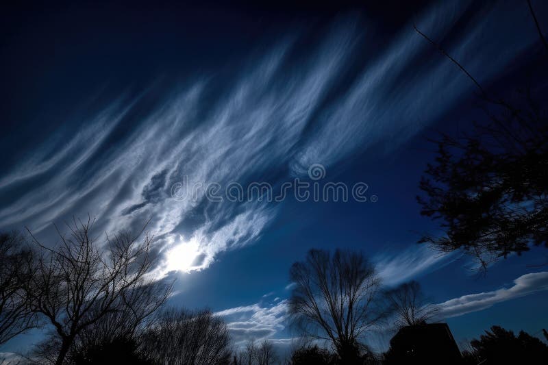 Dark Blue Sky with Wispy Clouds and Glimpse of the Sun Stock ...