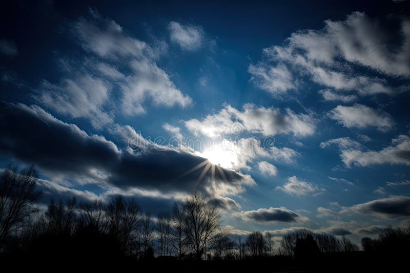 Dark Blue Sky, with Wispy Clouds and Sun Peeking through Stock ...