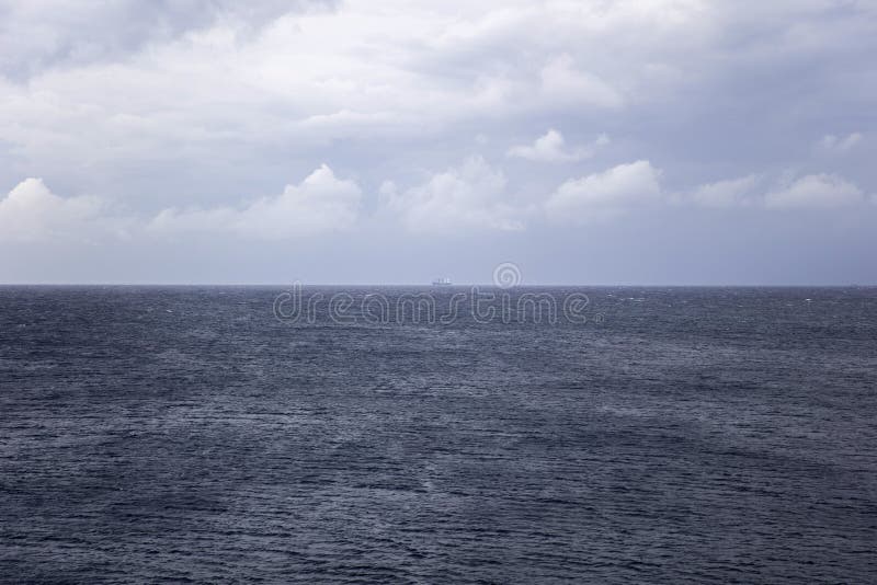 Dark Blue Water Surface at Deep Sea with a Ship on a Distant Horizon ...