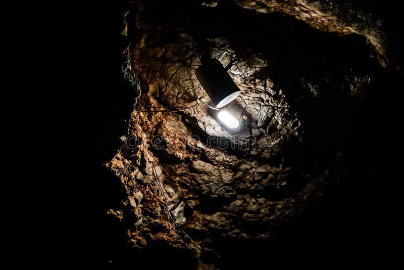 Dark Cave Wall Illuminated by Lamp Stock Photo - Image of electricity ...