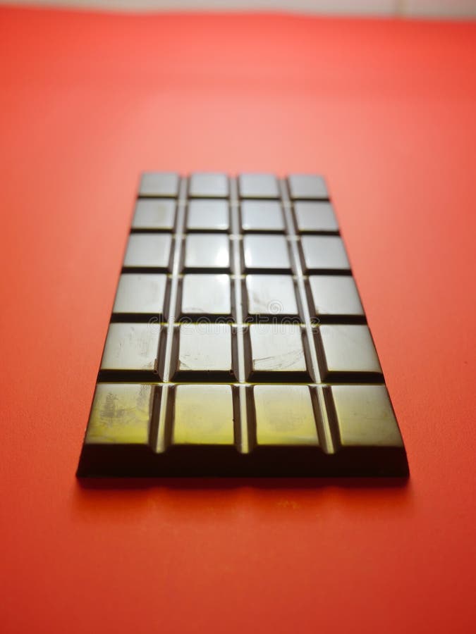 Chocolate Bar on a Red Background Stock Photo - Image of black, fresh ...