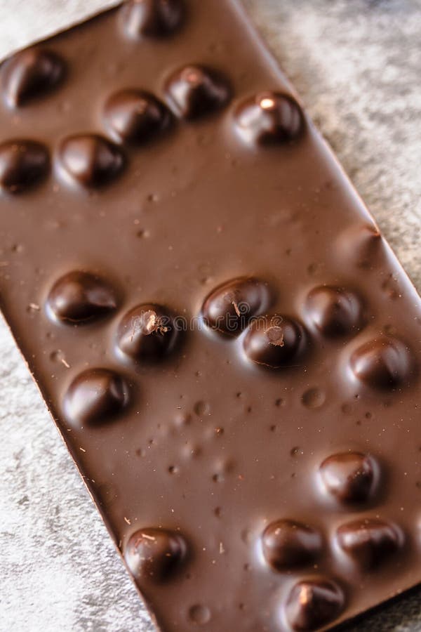 Dark Chocolate with Hazelnuts in the Shel on Gray Backgroundl, Closeup ...