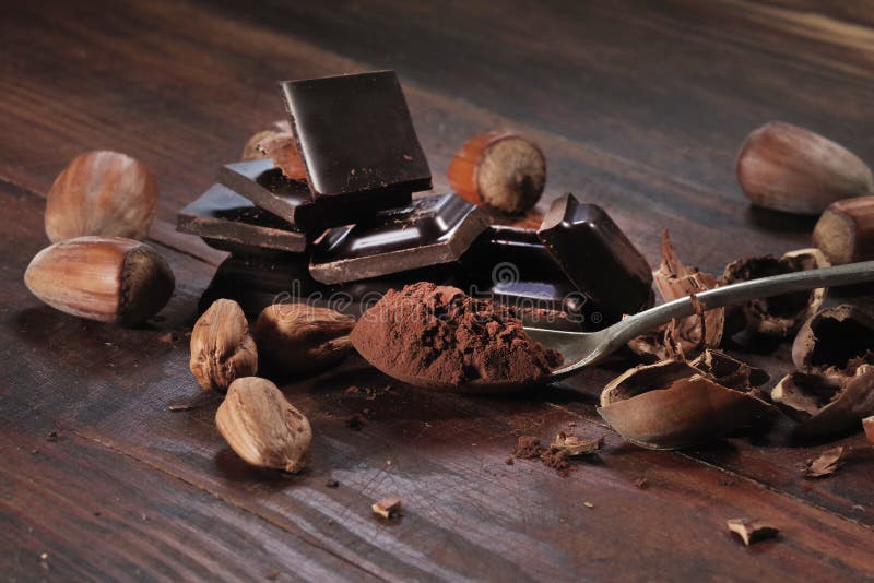 Dark Chocolate and Hazelnuts on Wooden Table Stock Photo - Image of ...