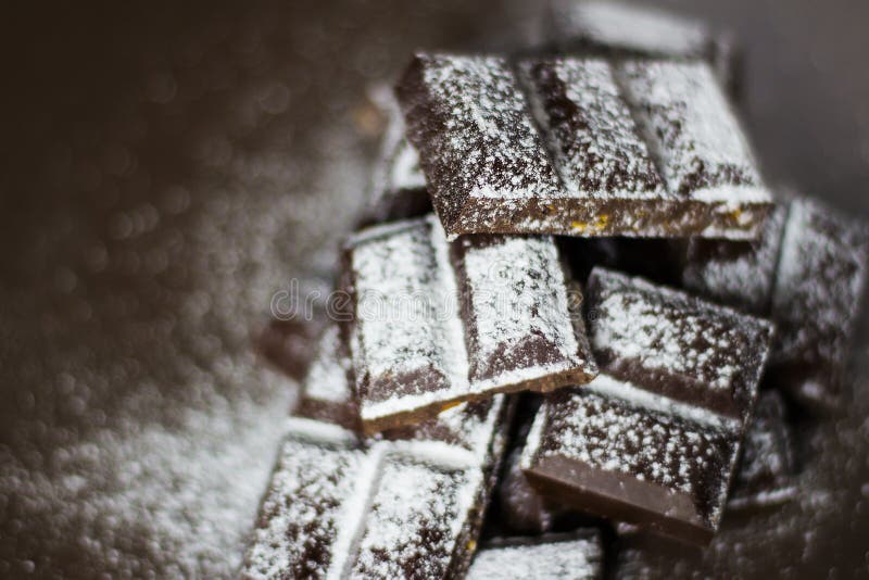 Dark Chocolate in Powdered Sugar. Chunks of Dark Chocolate Stock Image ...