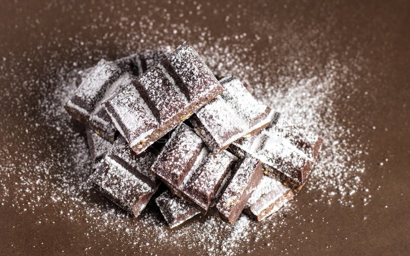 Dark Chocolate in Powdered Sugar. Chunks of Dark Chocolate Stock Photo ...