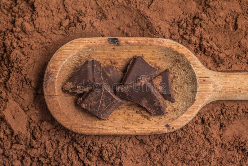 Dark Chocolate into a Spoon Over a Cocoa Powder Stock Image - Image of ...