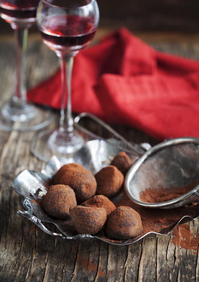 Dark Chocolate Truffles and Two Glasses of Raspberry Liqueur Stock ...