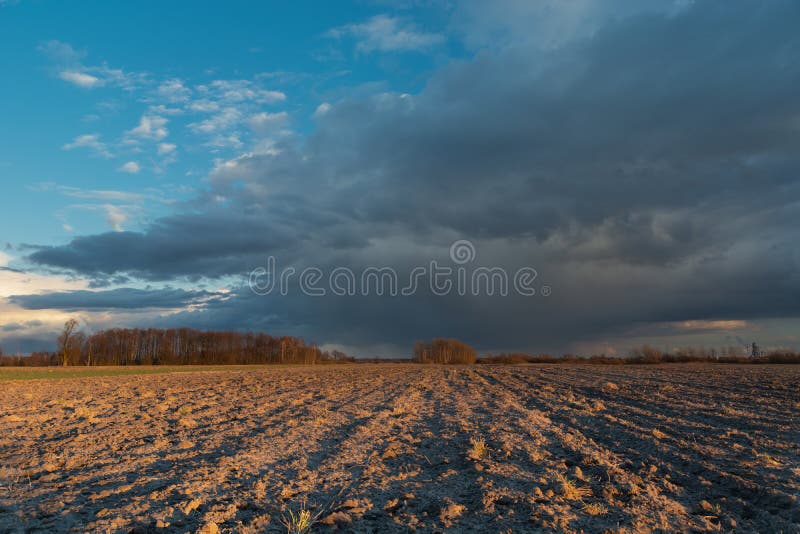 Dark Cloud on a Blue Sky Over a Big Plowed Field Stock Image - Image of ...