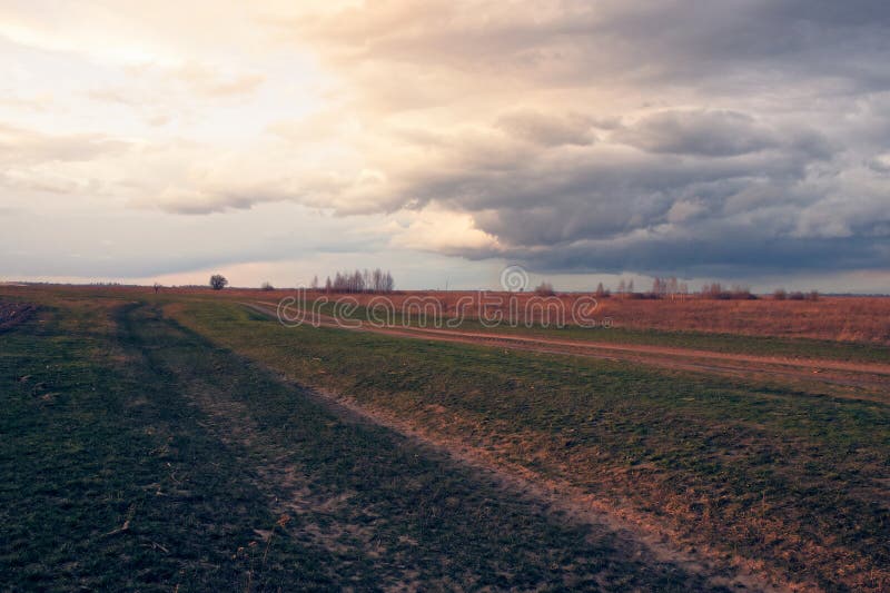 Dark Clouds Forming Over a Large Empty Field Stock Photo - Image of ...