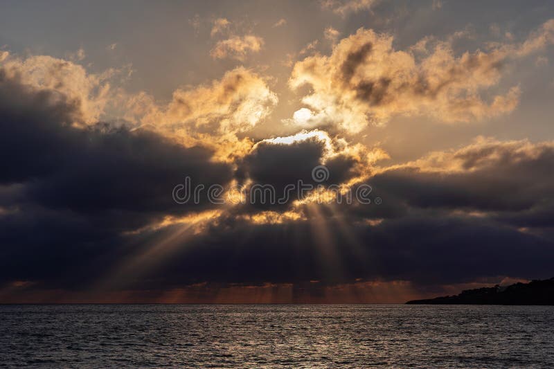 Dramatic Sunset Sky with Sun Rays Breaking through Clouds Over Ocean ...
