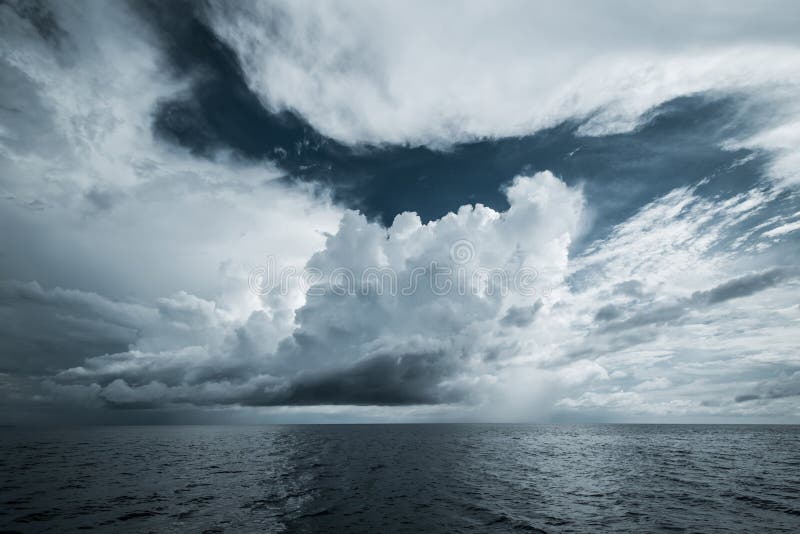 Dark clouds in open ocean stock photo. Image of dark - 112374820