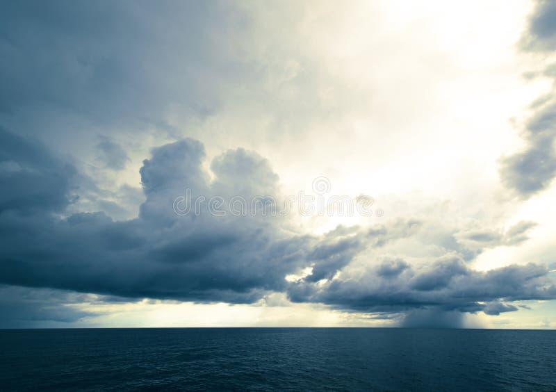 Dark clouds in open ocean stock photo. Image of destination - 101128970