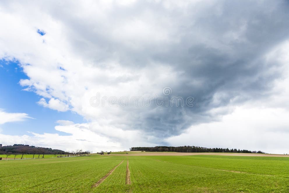 Dark Clouds Over Fields in Spring Stock Image - Image of blue, brown ...