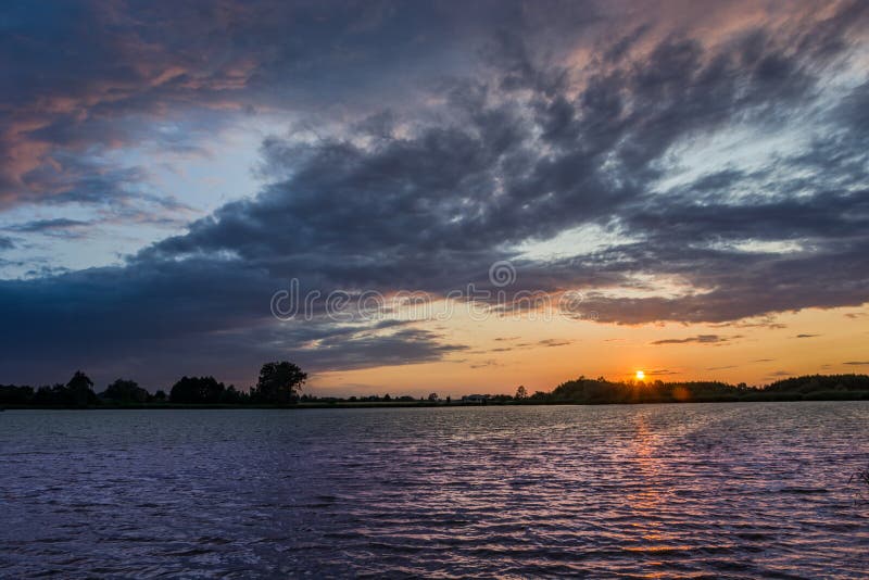 Dark Clouds on the Sky Over the Lake and Sunset Stock Image - Image of ...