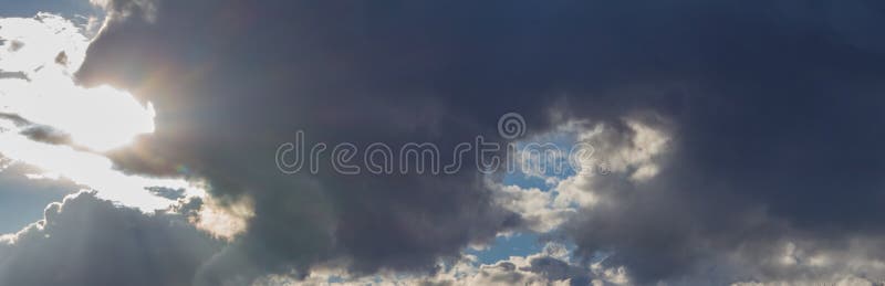 Dark clouds and sun rays stock photo. Image of sunlight - 249973020