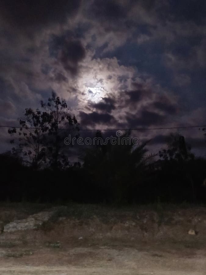Dark and Cloudy Night Sky with Faint Moonlight Stock Image - Image of ...