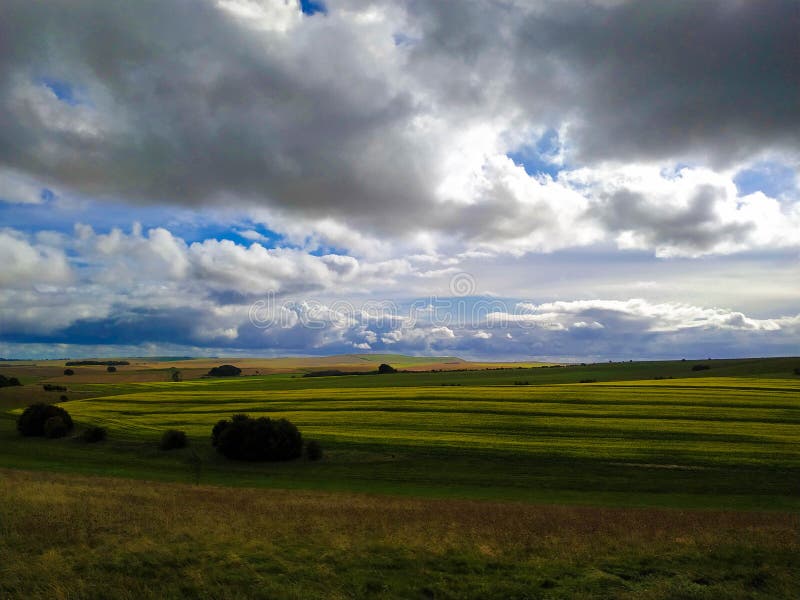 Dark Cloudy Sky and Bright Field Stock Image - Image of field, valley ...