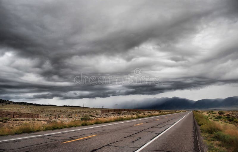 Dark, cloudy sky over road stock photo. Image of rain - 17750046