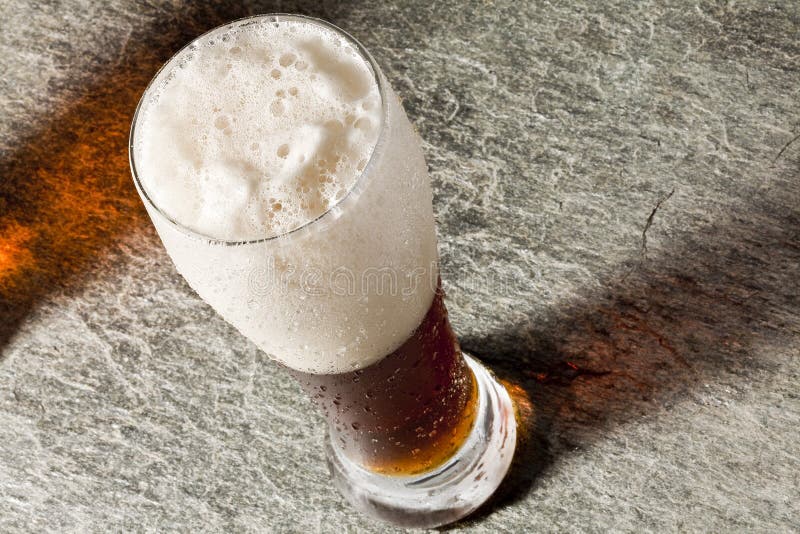 Dark cold beer with frothy stock image. Image of glass - 19144057