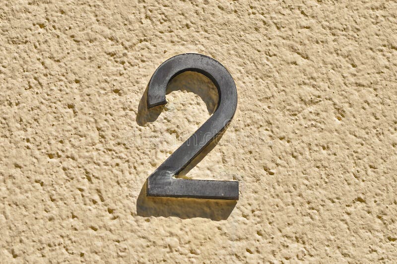 Dark Coloured Digit on a Yellow Background, Showing the Number Two ...