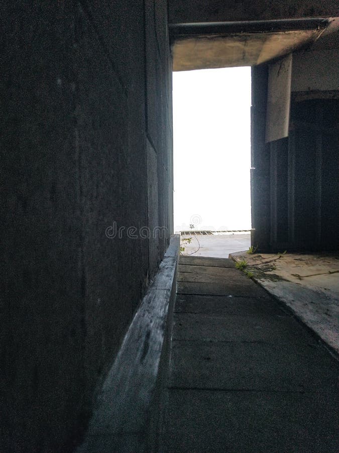 Dark Concrete Passage with Bright White Opening Ahead Stock Image ...