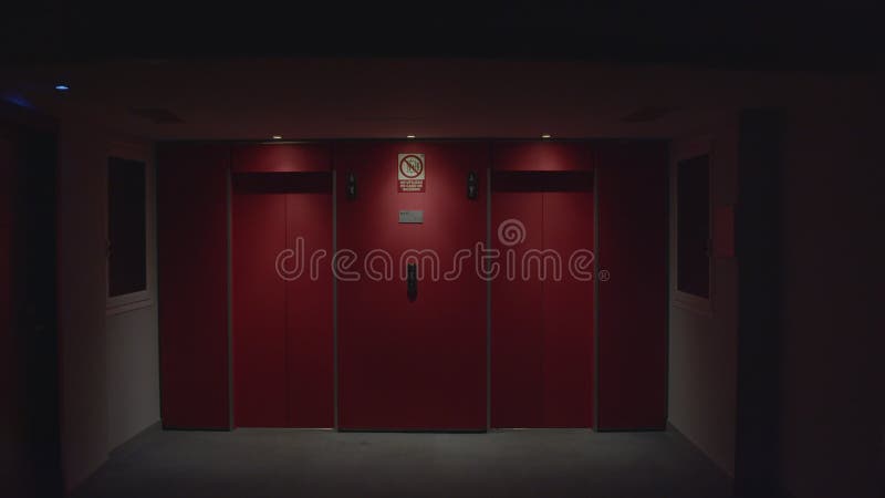 Approaching Red Elevator Doors in Dark Corridor Stock Footage - Video ...