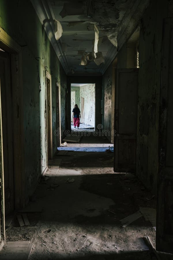 Dark, Decaying Hallway in Abandoned Building and Silhouette of Person ...