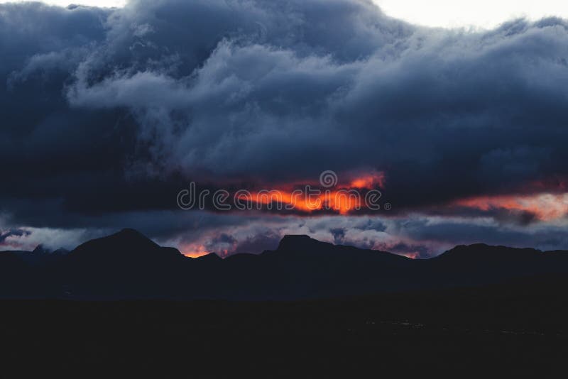 Dark Fluffy Flaming Clouds Over the Hills Stock Image - Image of ...