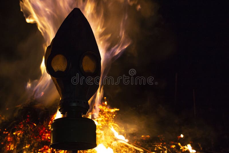 Dark Gas Mask on a Blurred Background of Fire and Ash in Fires in ...