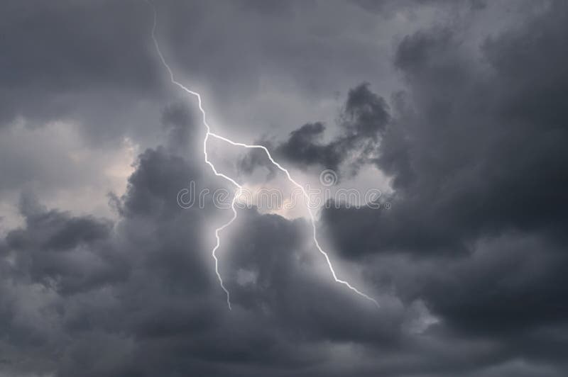 A Flash of Lightning in the Dark Sky with Gloomy Clouds Stock Photo ...