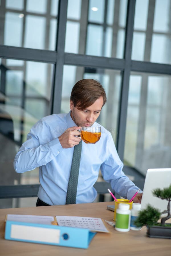Dark-haired Businessman Drinking Tea in the Office Stock Image - Image ...