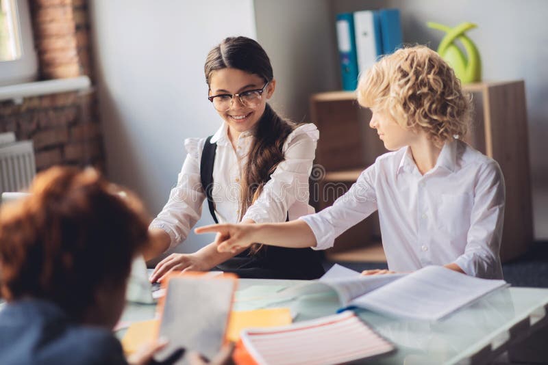 Dark-haired Girl Explaining Material To Her Friends Stock Photo - Image ...