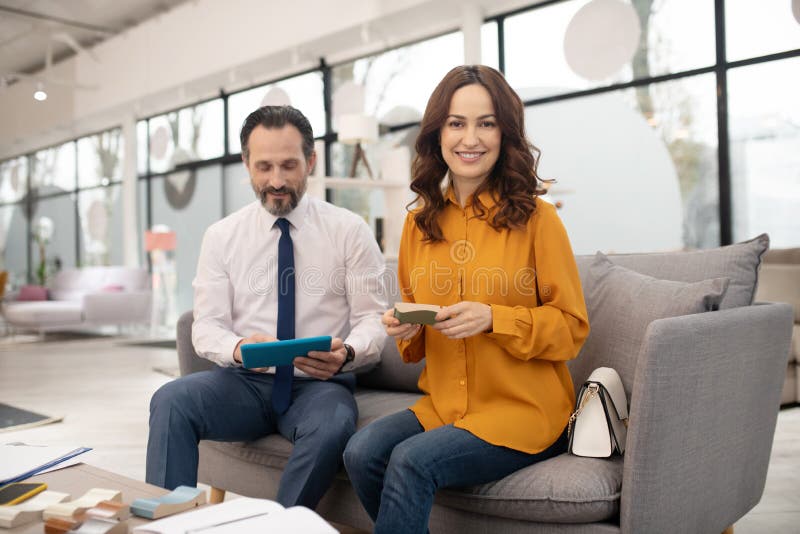 Dark-haired Pretty Customer in Yellow Shirt Holding Sample Stock Photo ...