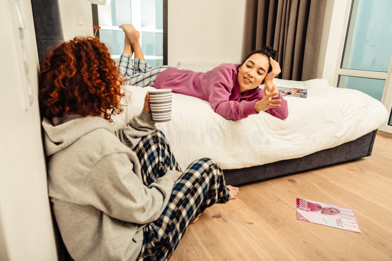 Dark-haired Roommate Talking To Her Curly Red-haired Friend Stock Photo ...