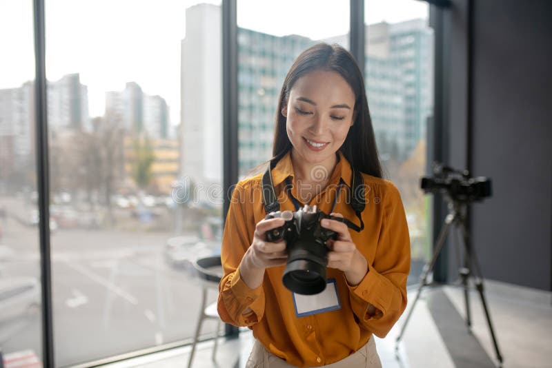 Dark-haired Young Cute Reporter Watching Photos in Camera Stock Photo ...