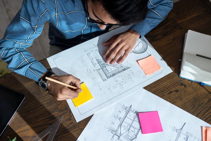 Dark-haired Young Man Sitting at the Table and Preparing a Project ...