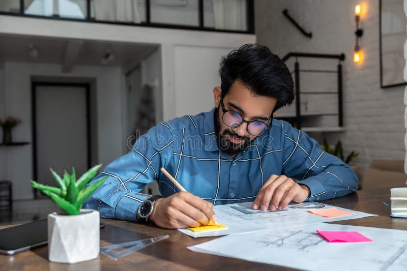 Dark-haired Young Man Sitting at the Table and Preparing a Project ...