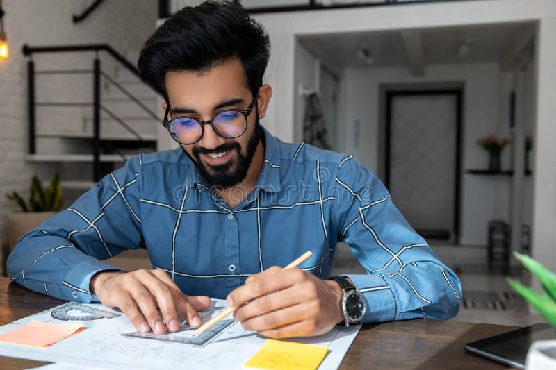 Dark-haired Young Man Sitting at the Table and Preparing a Project ...