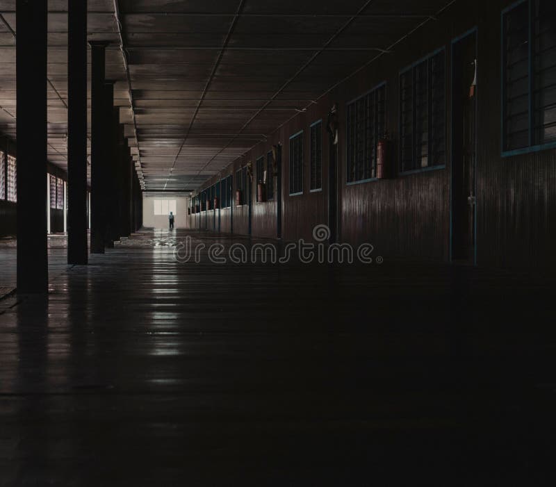 Dark Hallway with Arched Doorway with a View of a Concrete Building ...