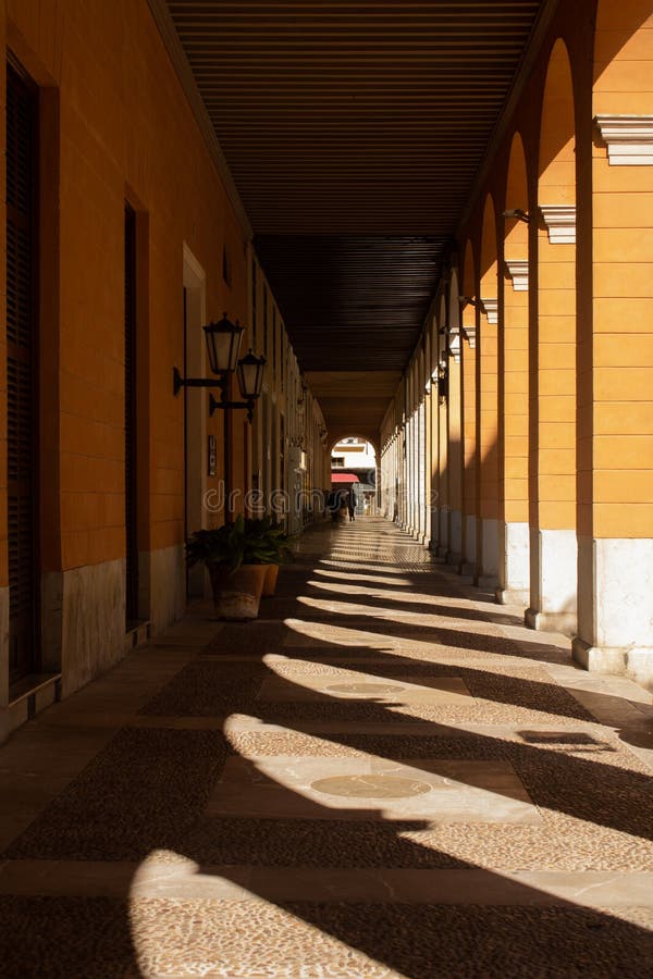 Dark Hallway with Sunlit Columns Stock Photo - Image of vanishing ...