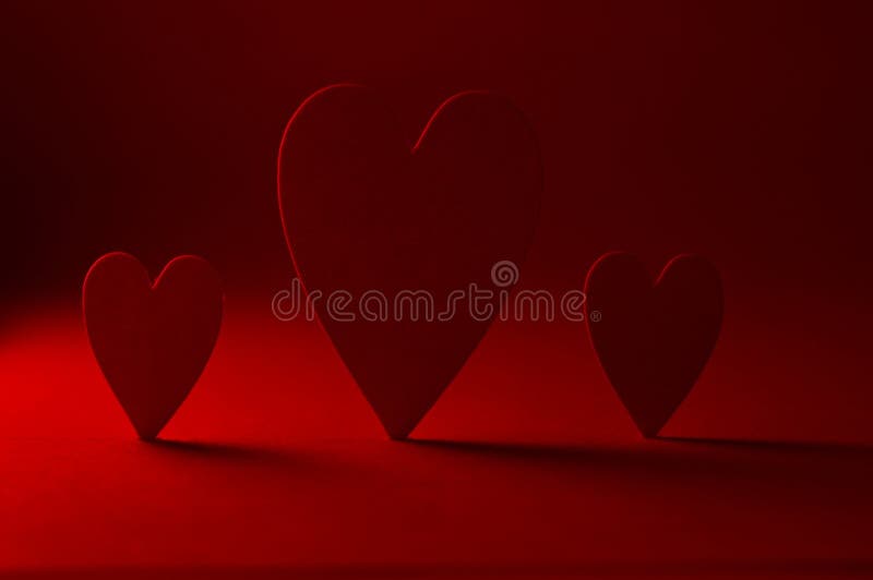 Dark Hearts on a Deep Red Backdrop Stock Image - Image of smaller ...