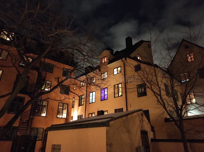 A Building with Some Windows Lit Up and Night Sky in the Background ...