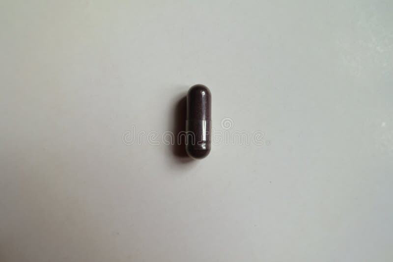 1 Dark Purple Capsule of Bilberry Extract Stock Image - Image of black ...