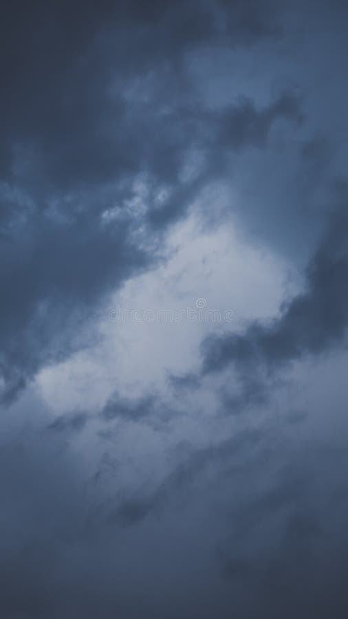 Dark Rainy Clouds with One Lighter Part in the Middle Stock Image ...