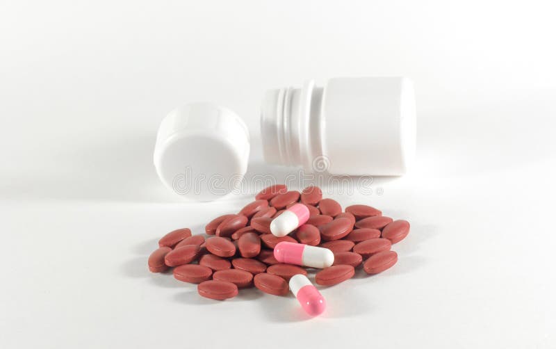 Dark Red and Pink Pills Spilling from a White Plastic Bottle Stock ...