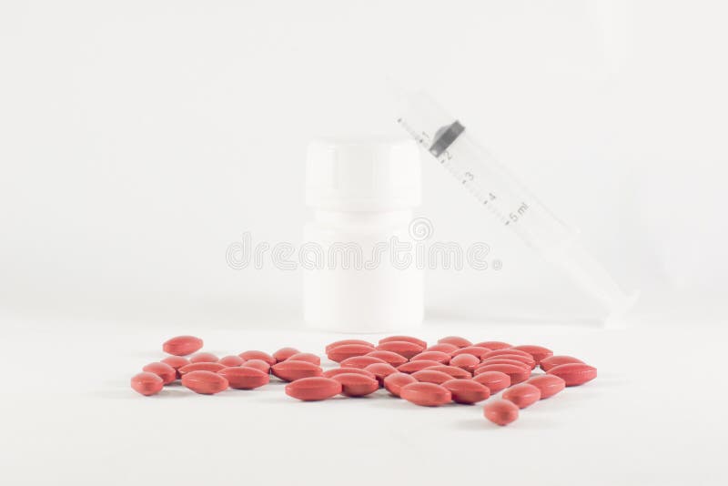 Dark Red and Pink Pills Spilling from a White Plastic Bottle Wit Stock ...