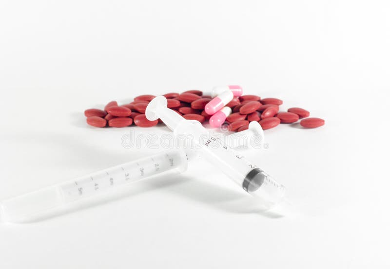 Dark Red and Pink Pills Spilling from a White Syringe. Stock Image ...