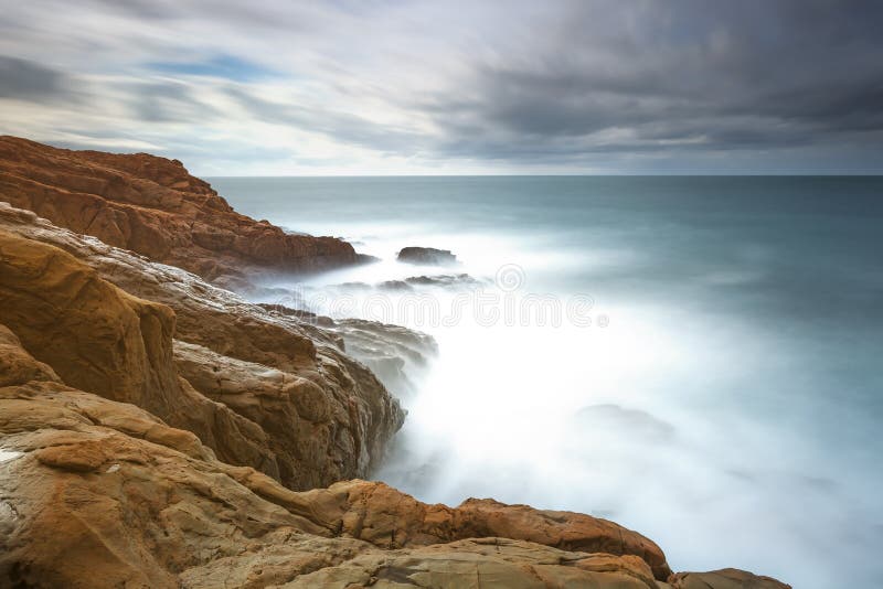 Dark Red Rocks, Foam and Waves, Sea Under Bad Weather. Stock Photo ...