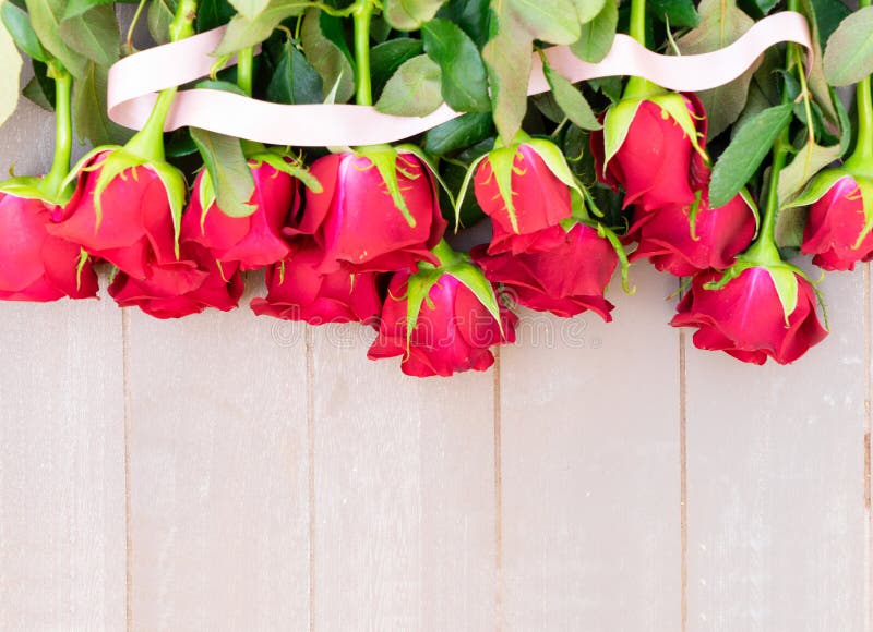 Dark red roses on table stock photo. Image of bright - 207485632