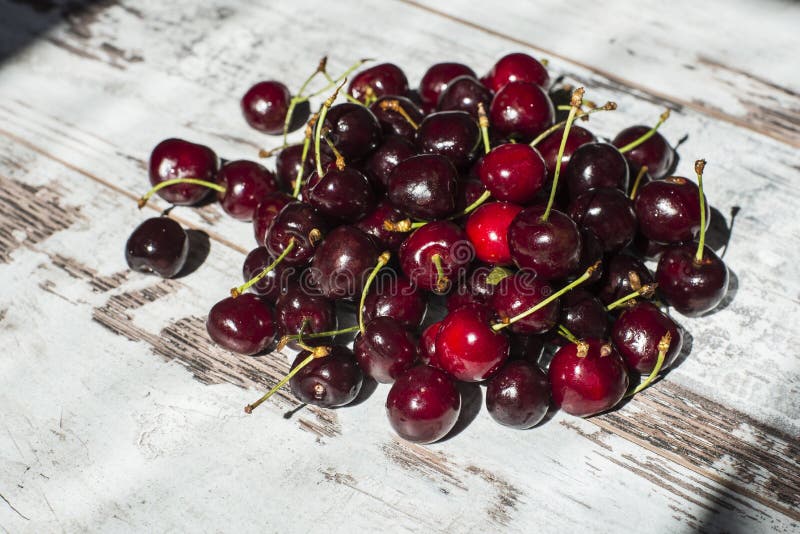 Dark Red Sweet Cherries Lying in Pile on Vintage-looking Table Side ...